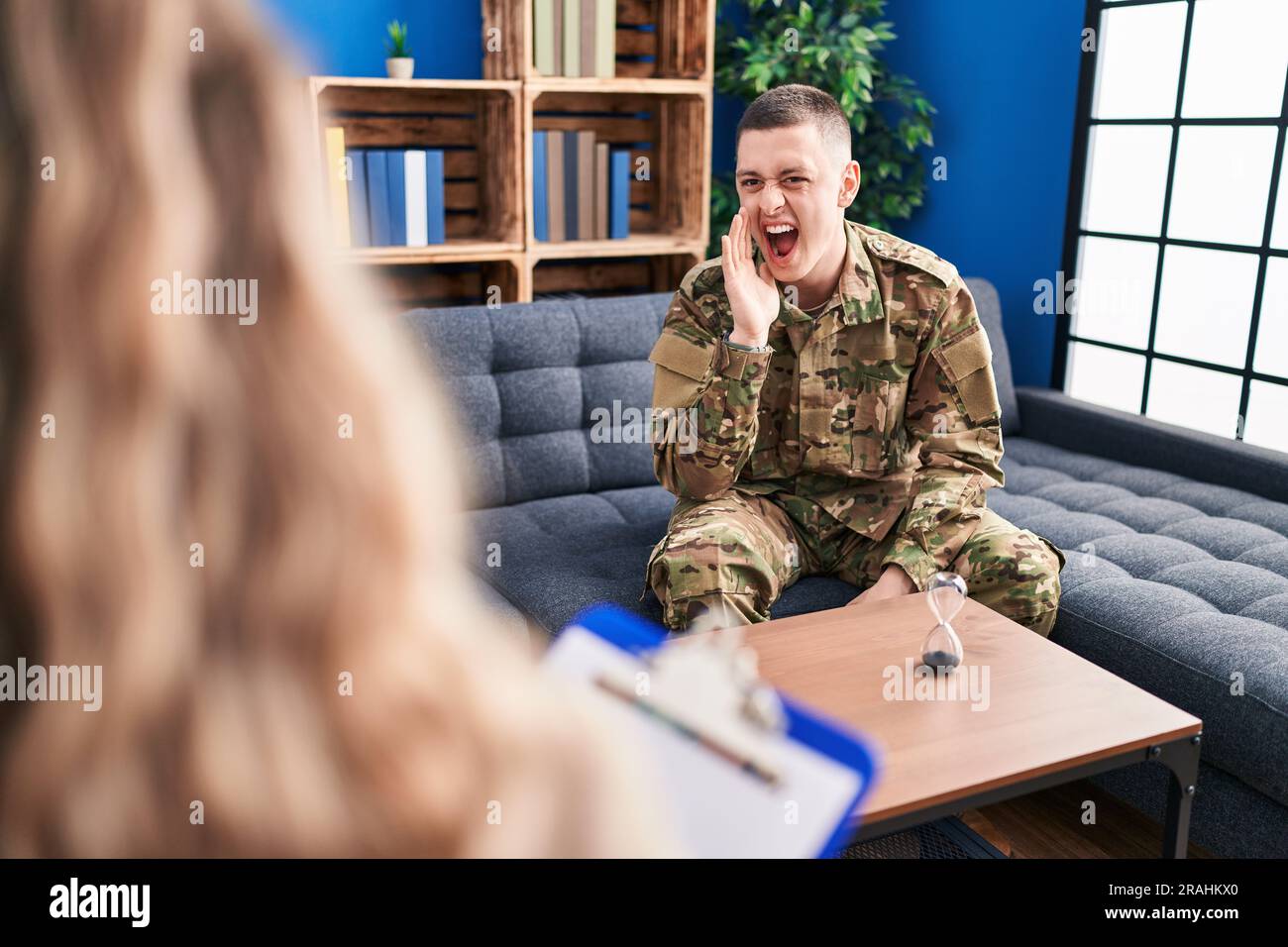 Young man doing therapy after war shouting and screaming loud to side ...
