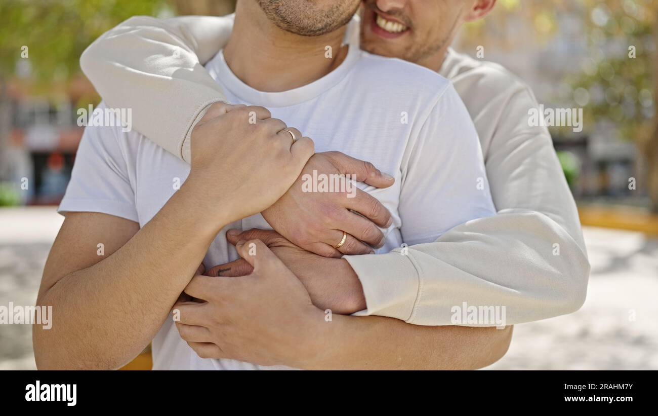 Two men couple smiling confident hugging each other at park Stock Photo ...
