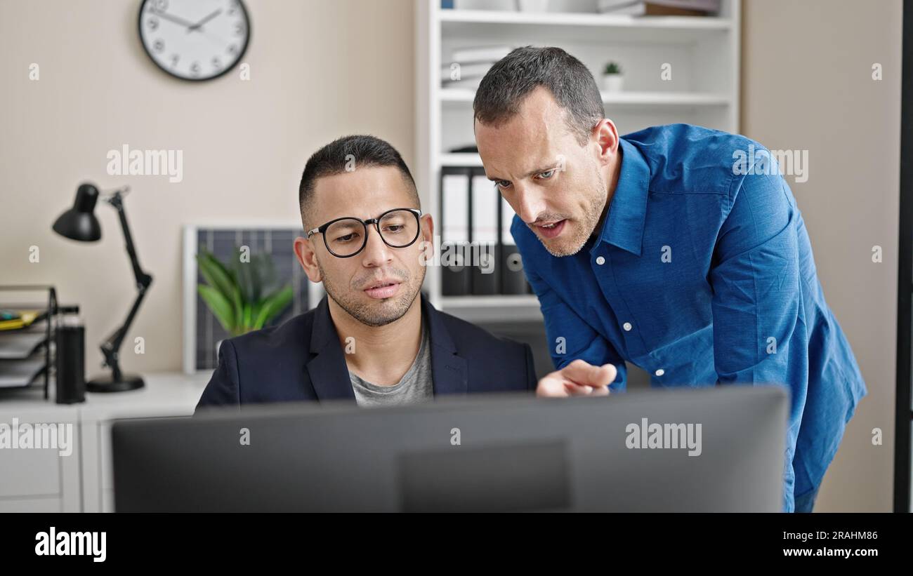 Two men business workers using computer and speaking at office Stock ...
