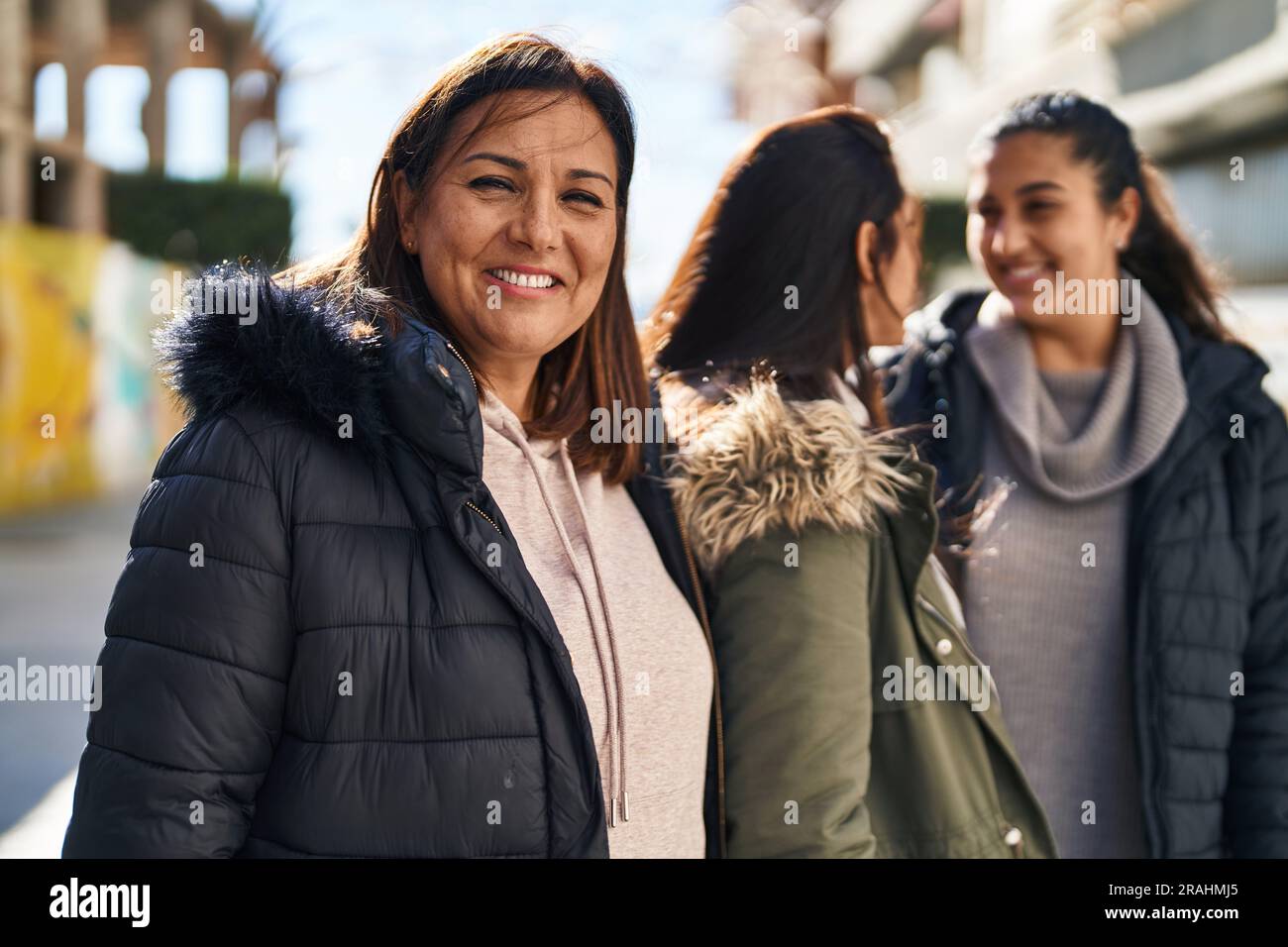 Three woman mother and daughters standing together at street Stock ...