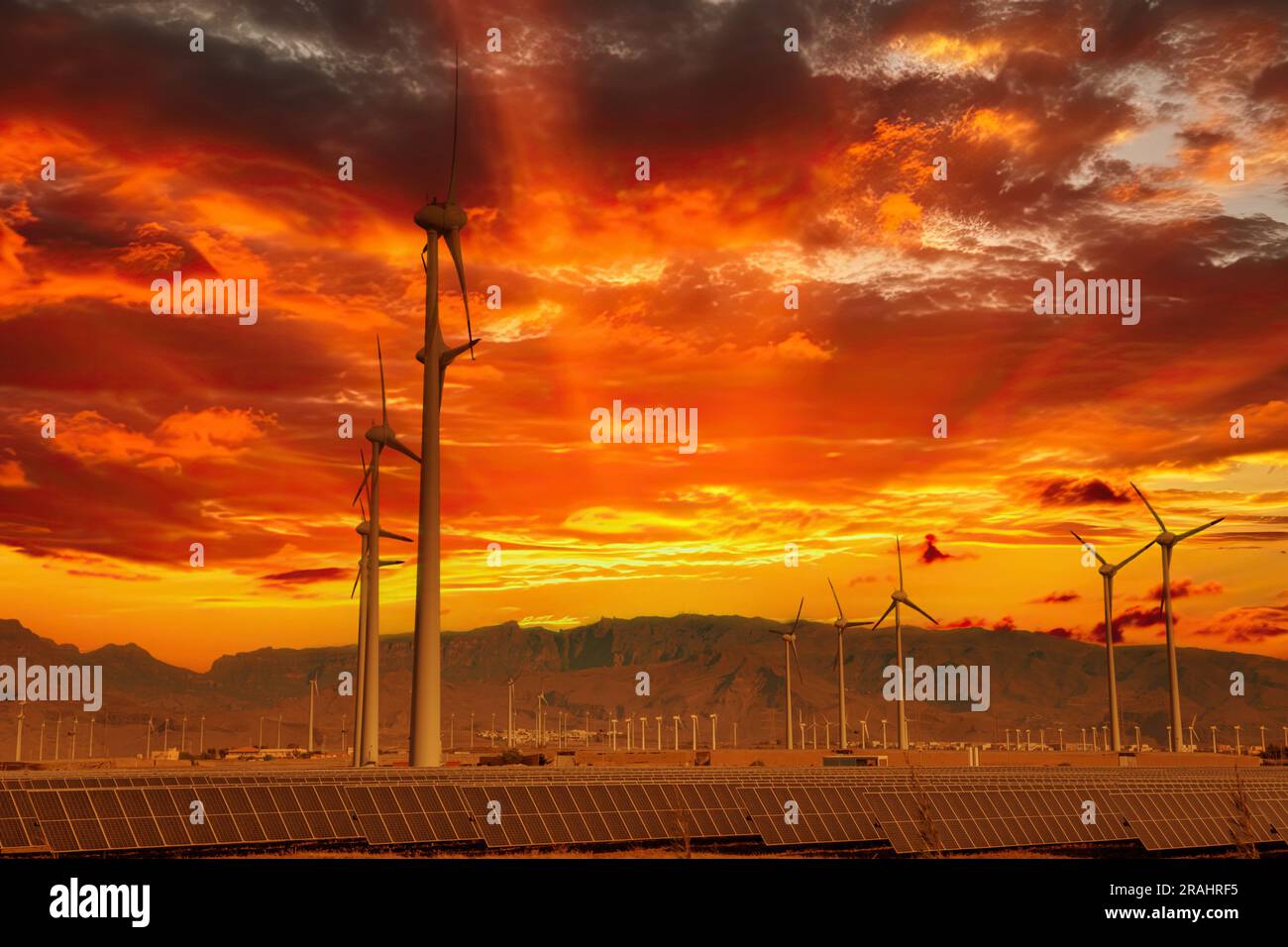 sunset power plant with wind turbines and solar panels. The marriage of ...