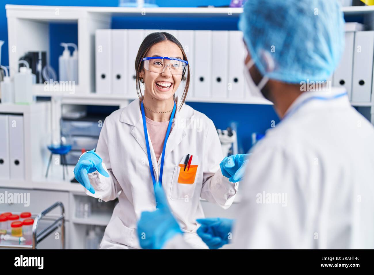 Man and woman scientists smiling confident speaking at laboratory Stock ...