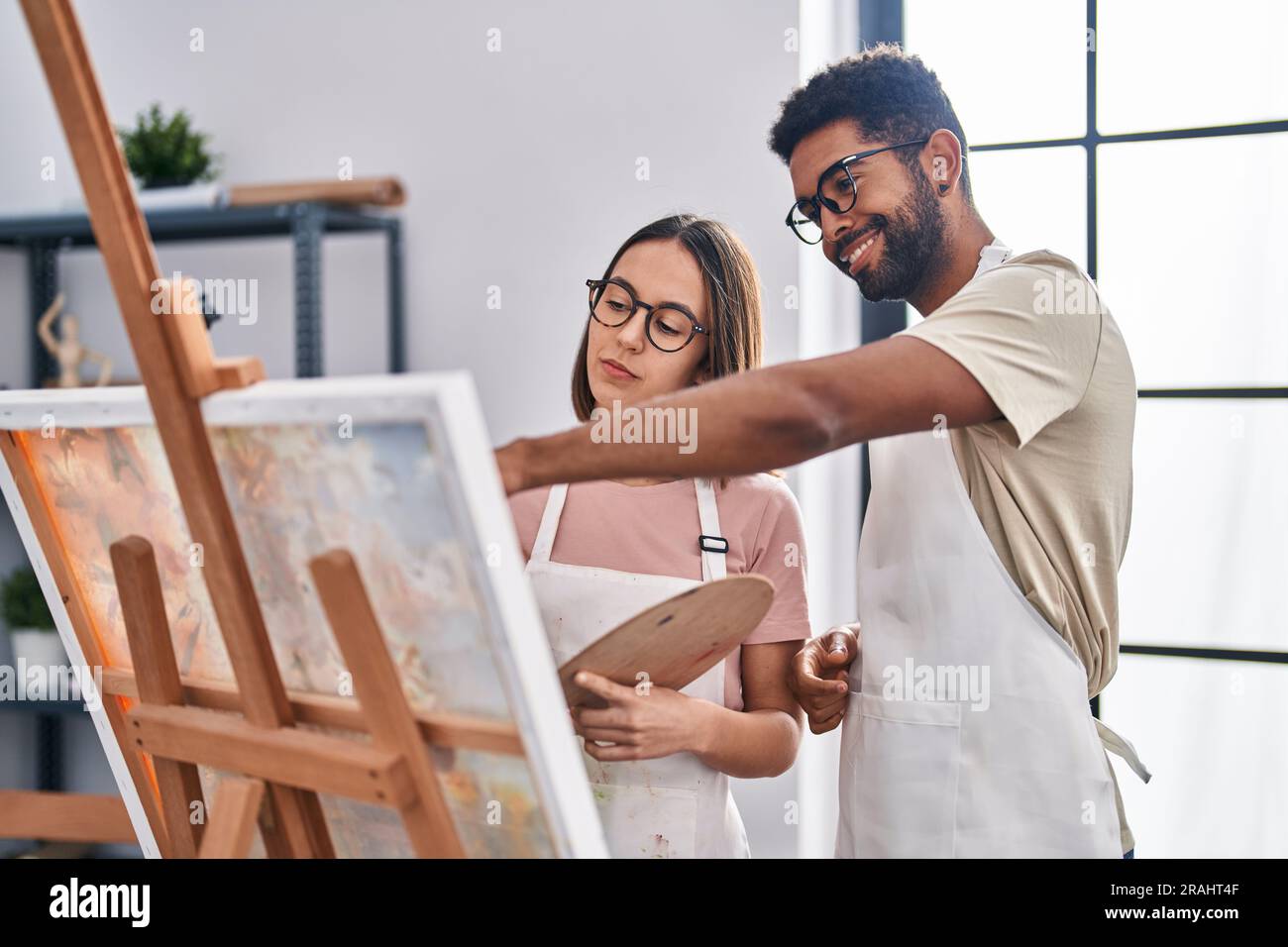 Man and woman artists smiling confident drawing at art studio Stock ...