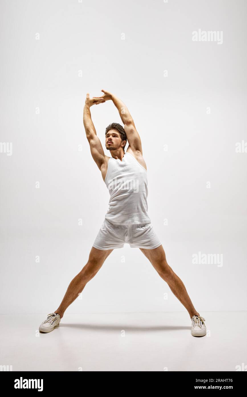 Studio shot of young attractive Caucasian man wearing homewear posing ...