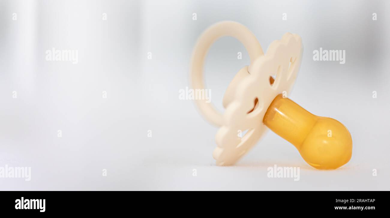 Baby's pacifier on a blurred white background Stock Photo - Alamy
