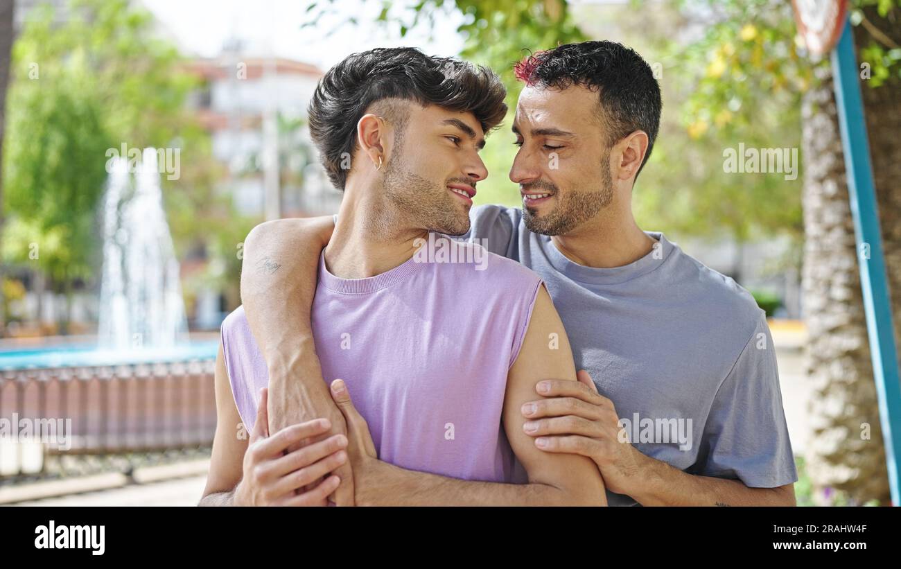 Two men couple smiling confident hugging each other at park Stock Photo ...