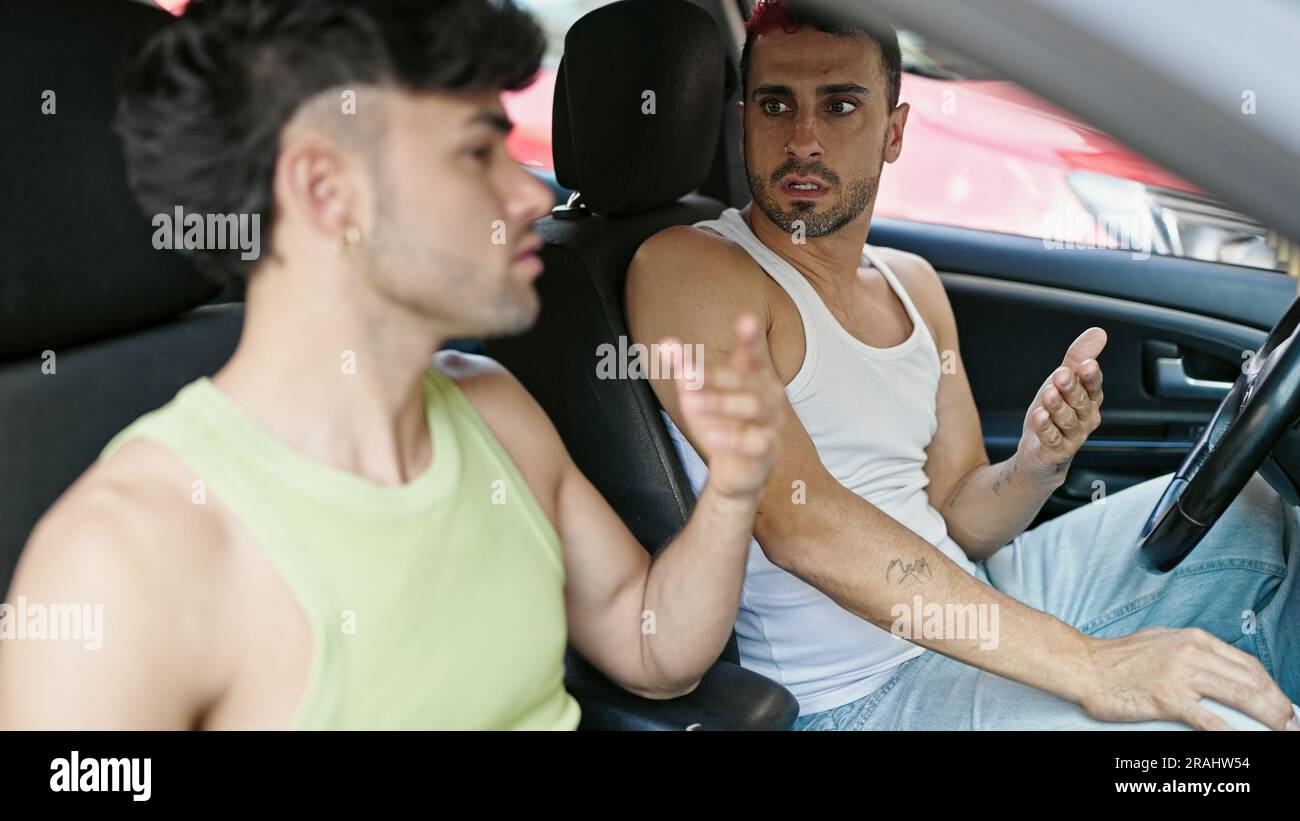 Two men couple driving car arguing at street Stock Photo - Alamy