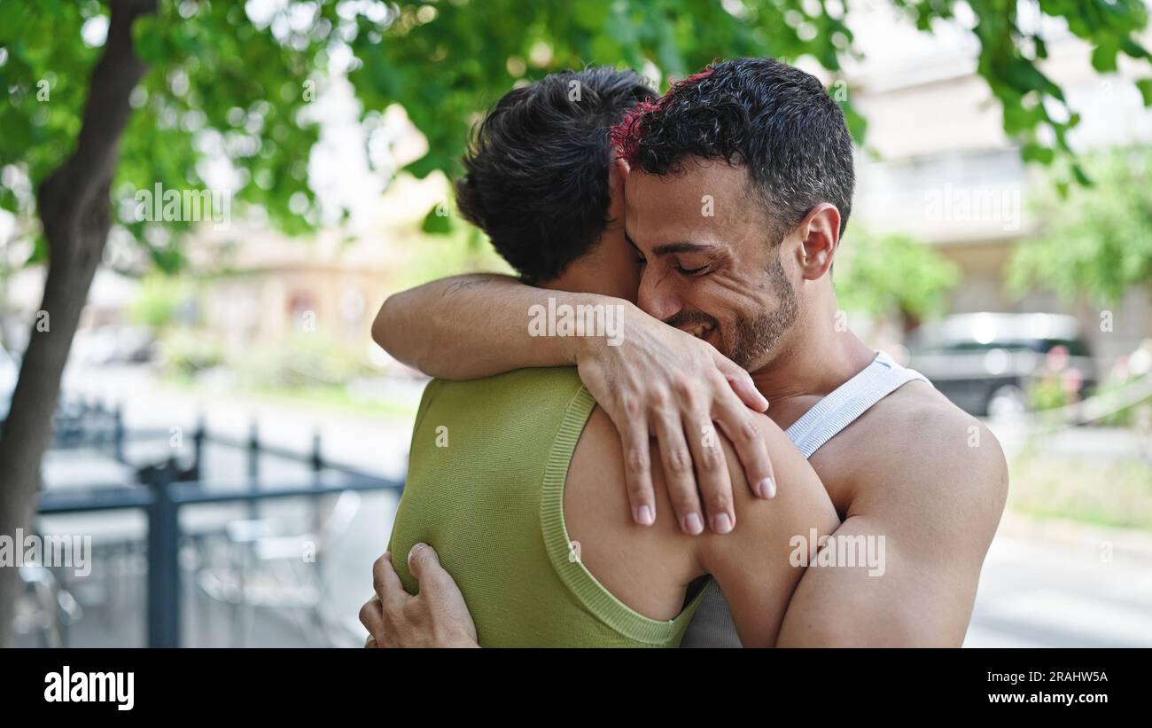 Two men couple smiling confident hugging each other at park Stock Photo ...