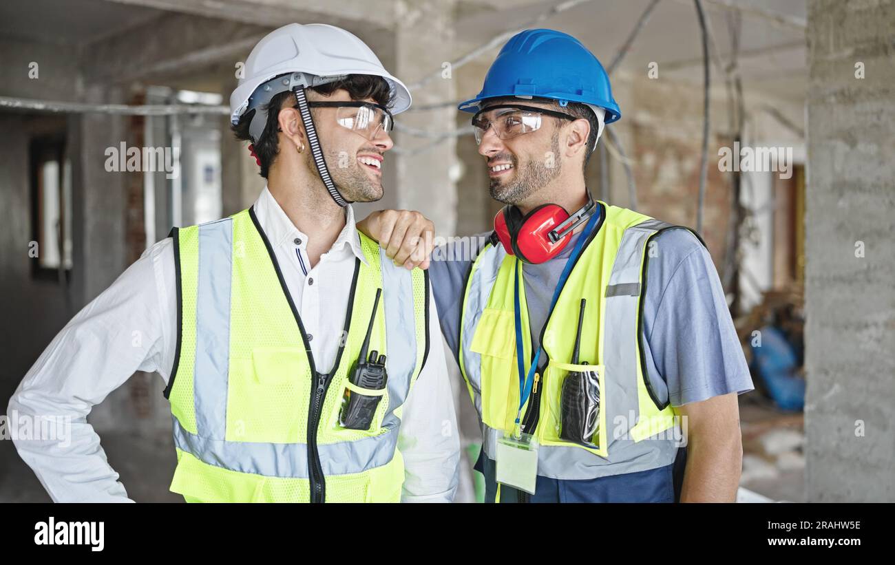 Two men builders smiling confident standing at construction site Stock ...