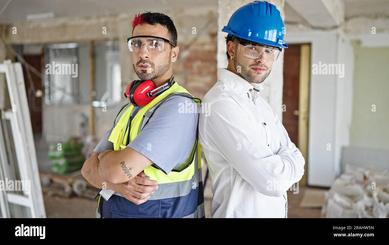 Two men builder and architect standing with arms crossed gesture at ...