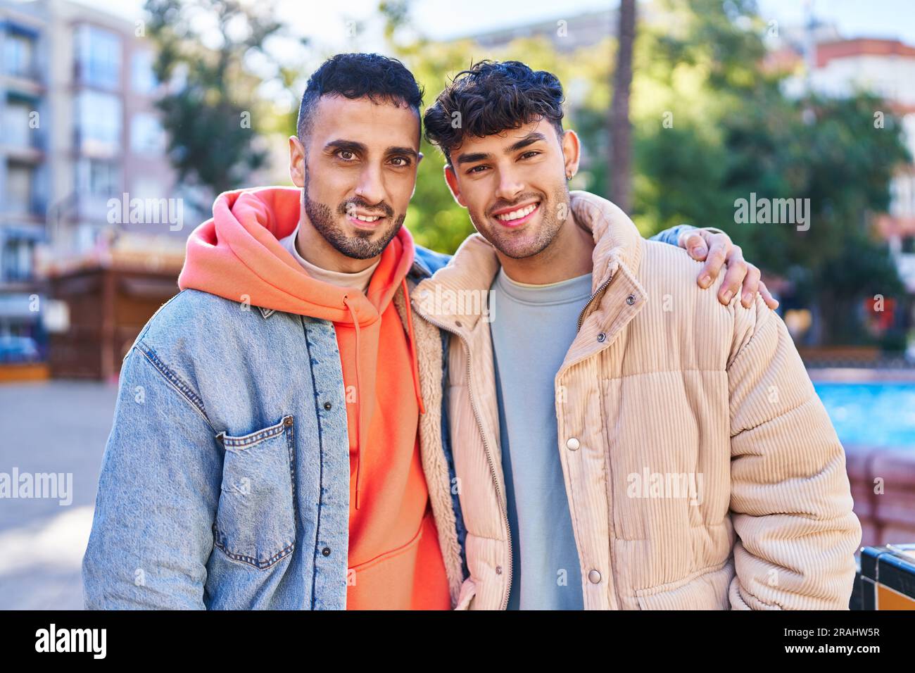 Two man couple hugging each other standing at park Stock Photo - Alamy