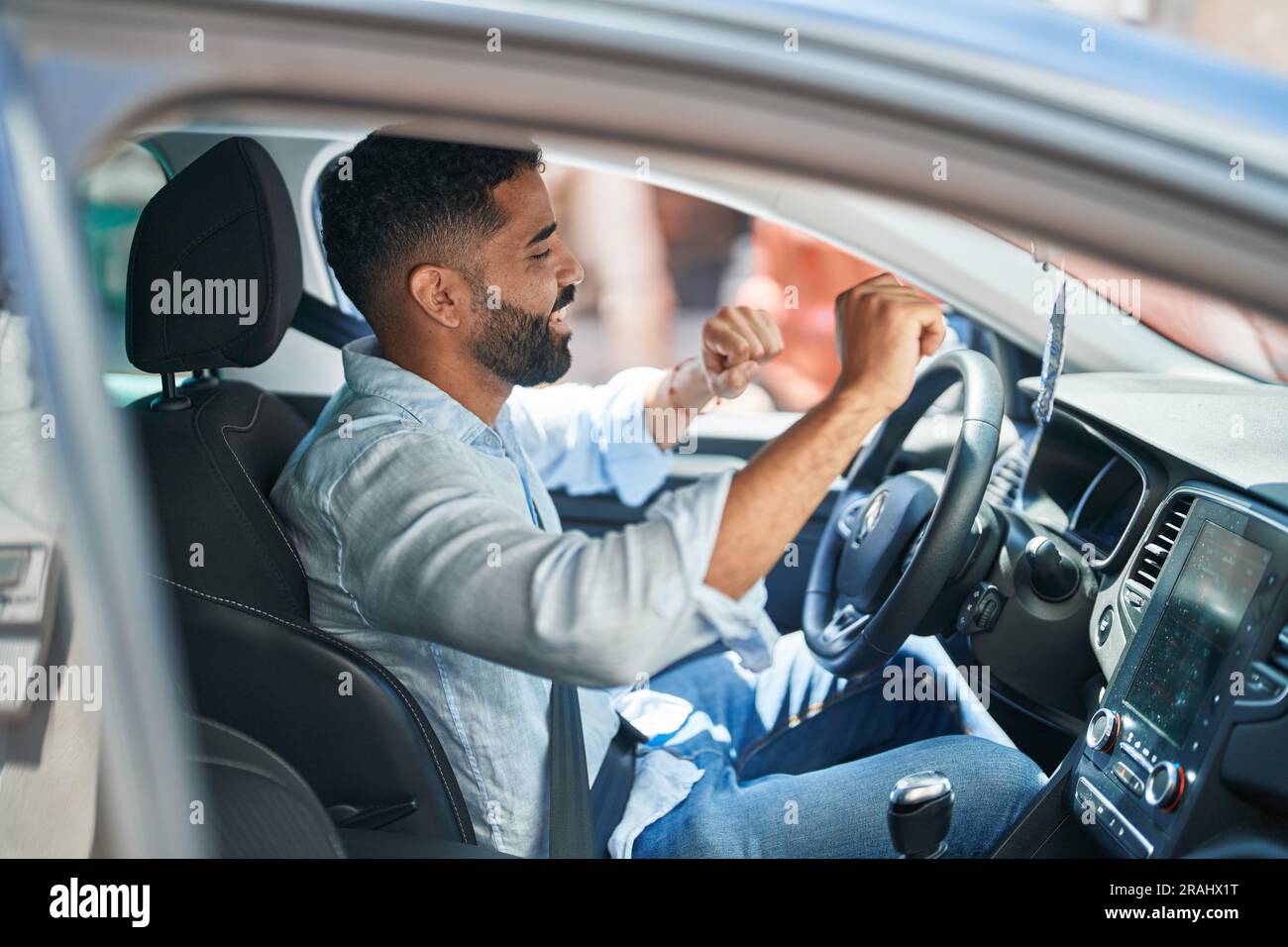 Man driving car dancing listening hi-res stock photography and images ...