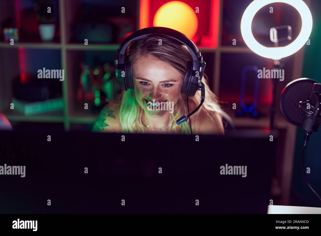 Young beautiful hispanic woman streamer playing video game using ...