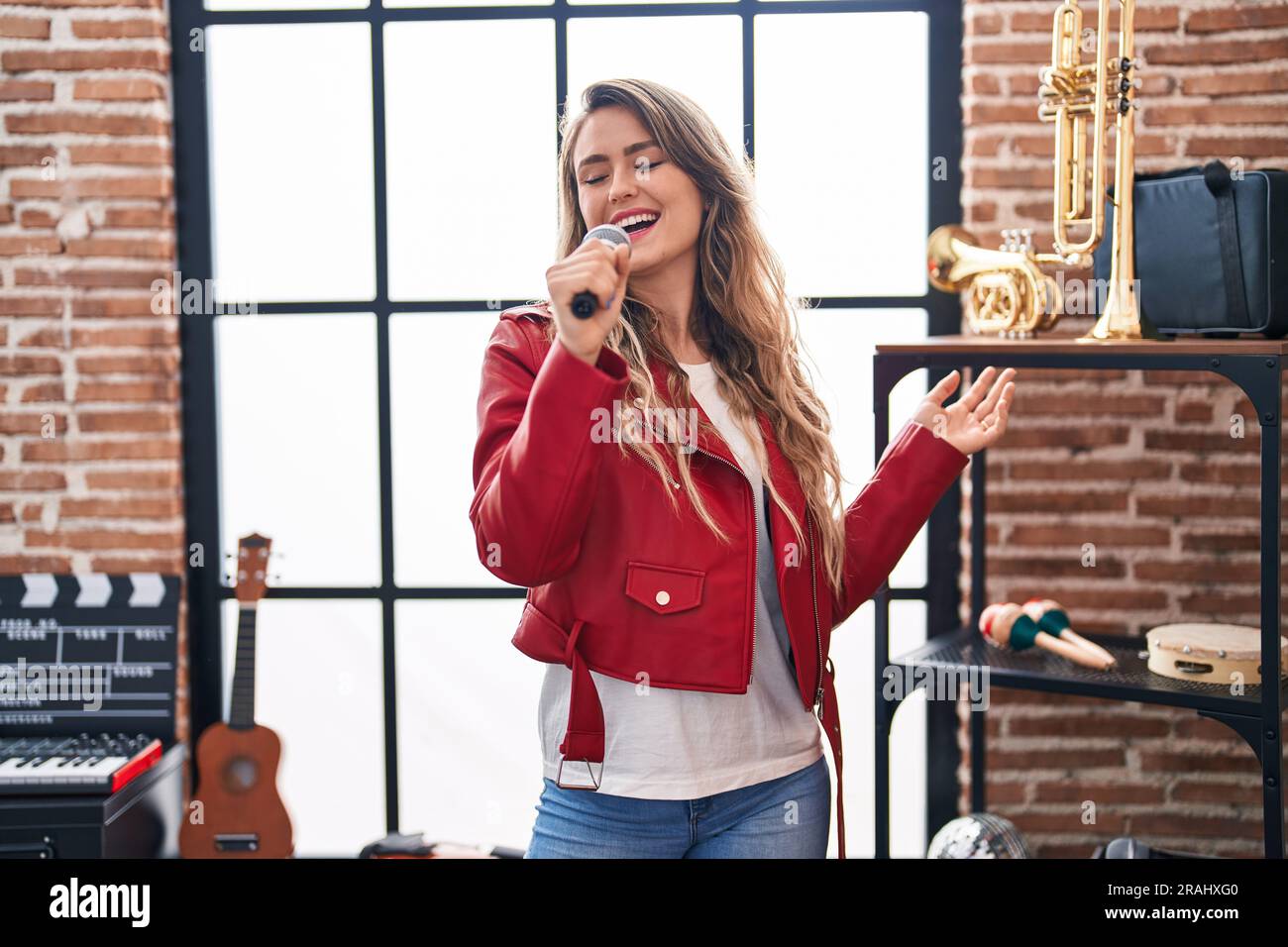 Young woman artist singing song at music studio Stock Photo - Alamy