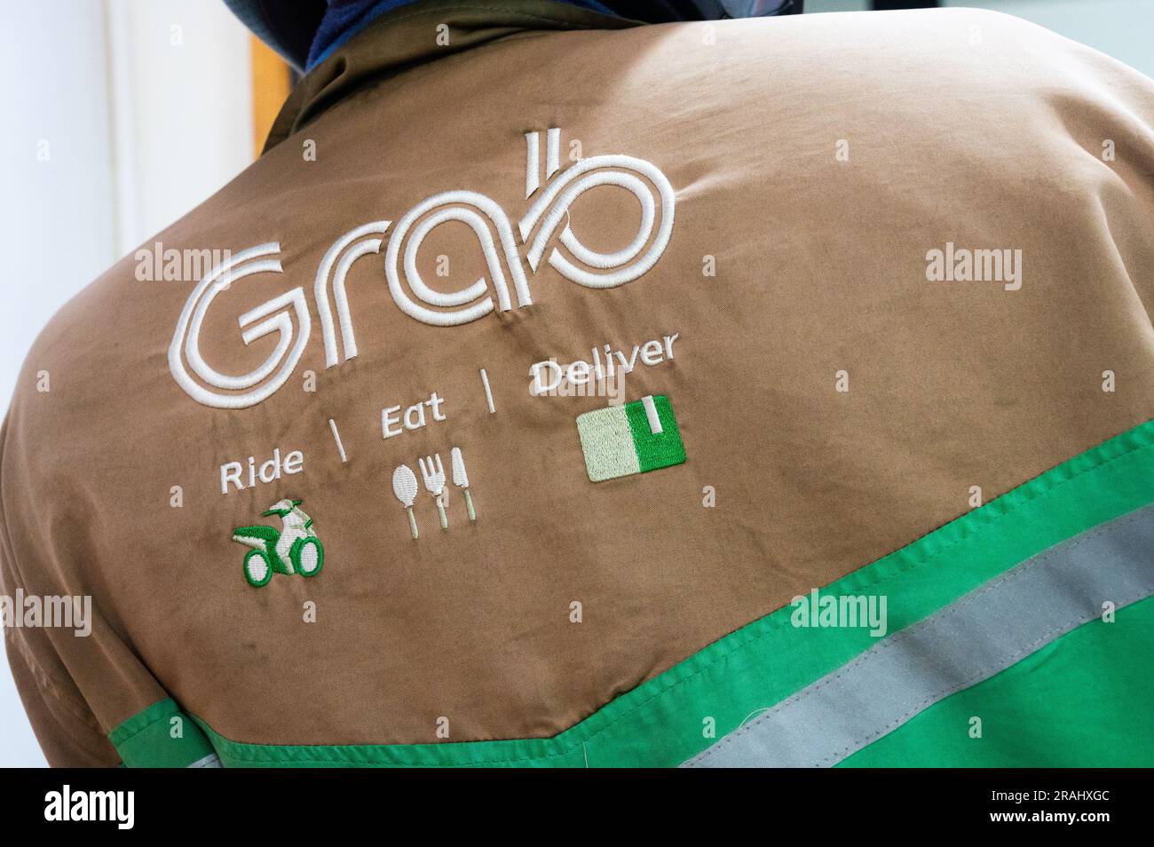 Grab motorbike courier waiting for food order in Bangkok, Thailand ...