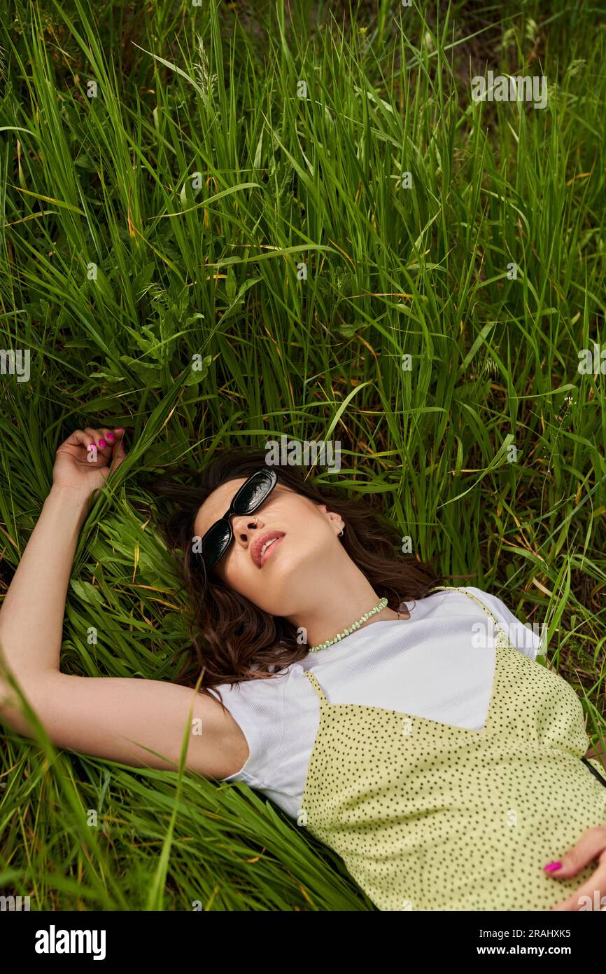 Chilling woman lying on grass hi-res stock photography and images - Alamy