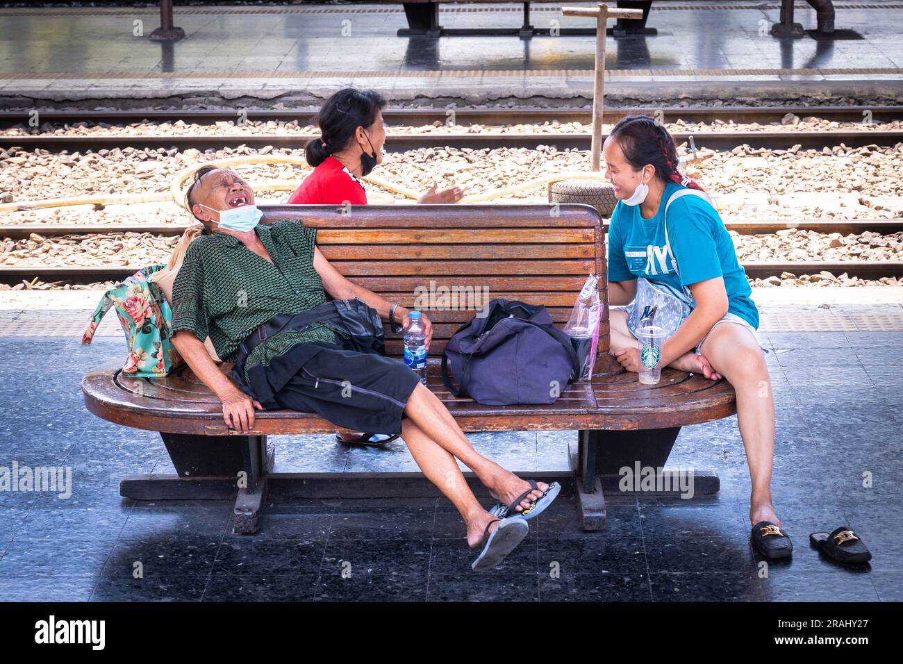 Thai hawkers laughing as they are waiting for a train from Hua Lamphong ...