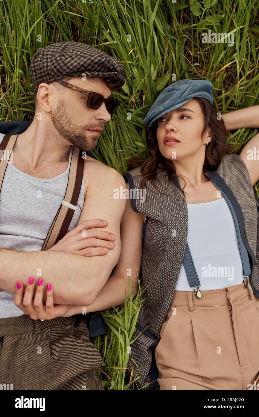 Top view of fashionable romantic couple in newsboy caps, suspenders and ...