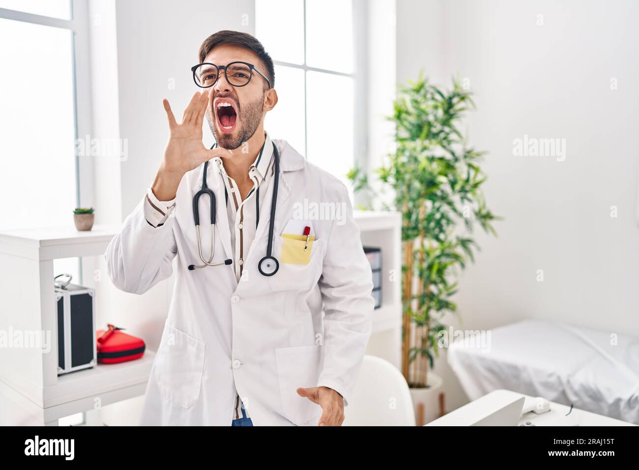 Hispanic man wearing doctor uniform and stethoscope clueless and ...