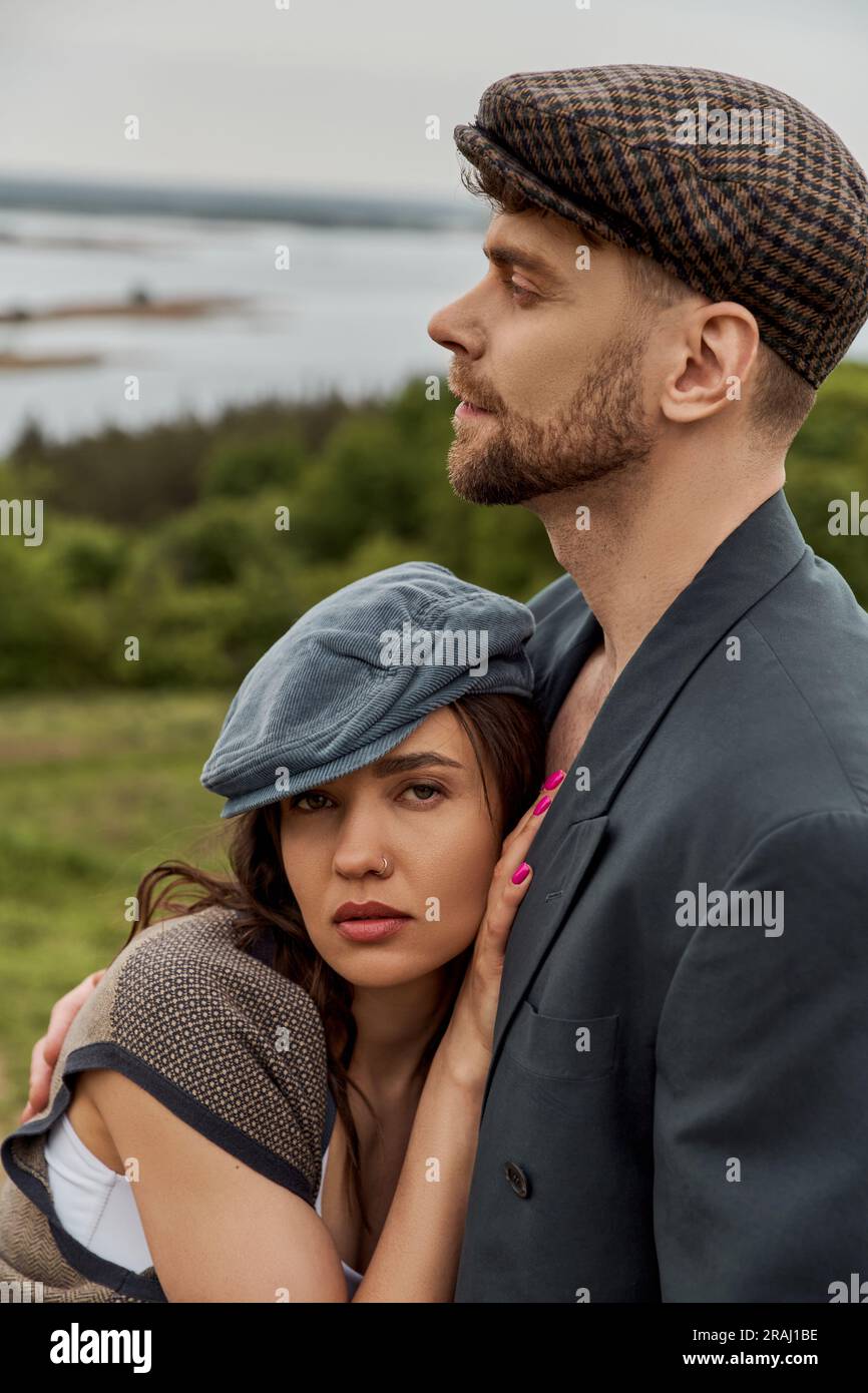 Portrait of trendy brunette woman in vest and vintage outfit hugging ...