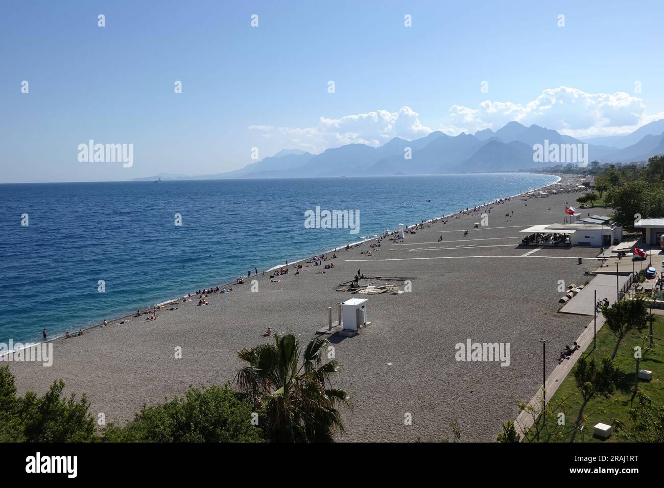 Sun, endless beach, cloudless sky, sea and far mountains in Antalya ...