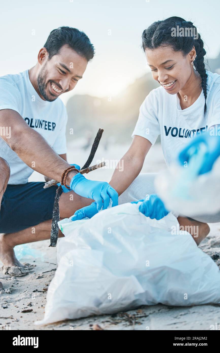 Volunteer, man and woman cleaning beach for world earth day, care and ...