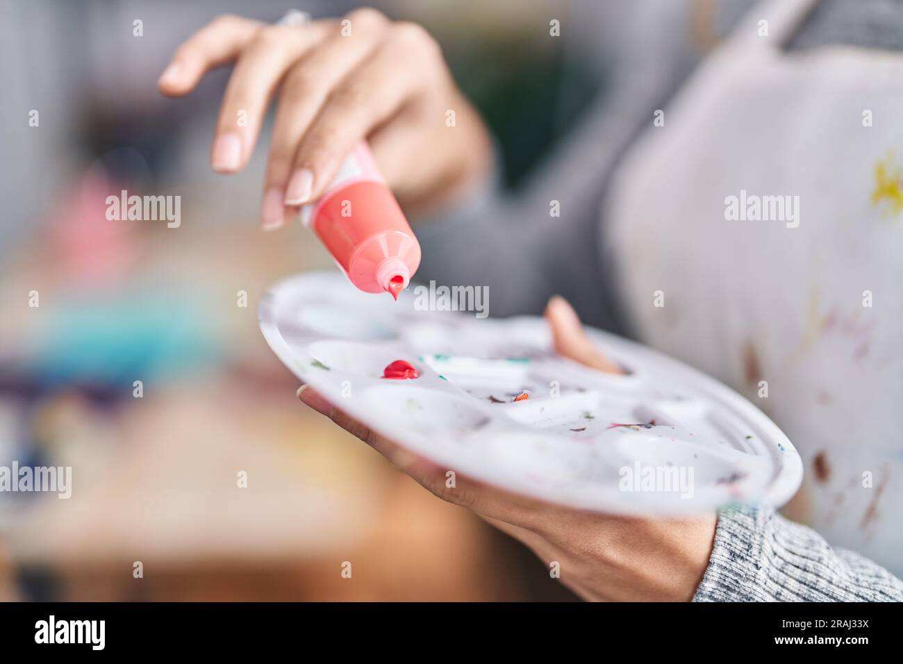 Young woman artist mixing color on palette at art studio Stock Photo ...