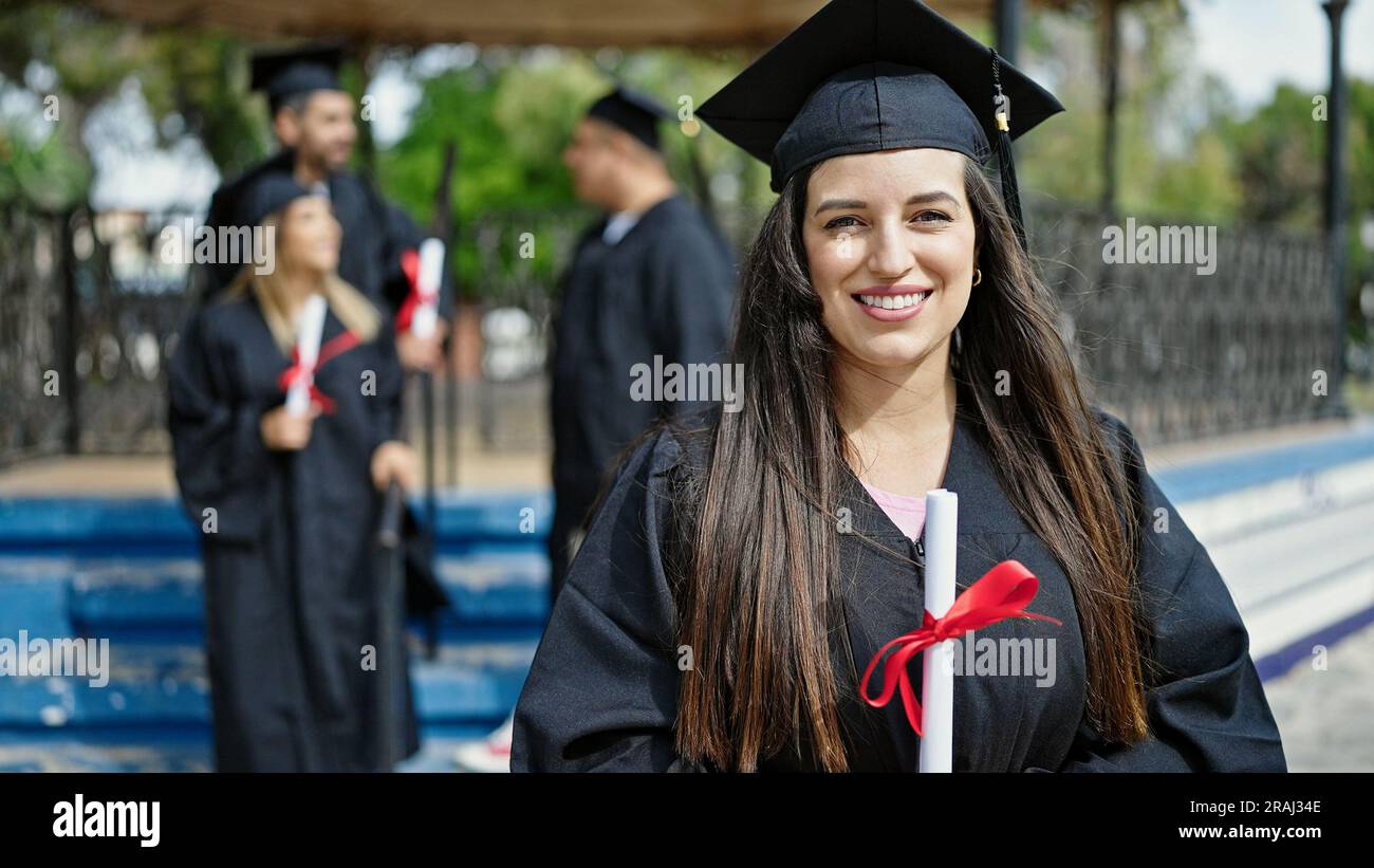 Group of people students graduated holding diploma at university campus ...