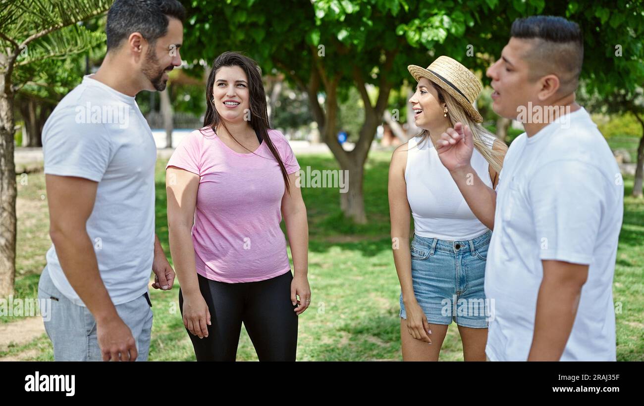 Group of people standing together speaking at park Stock Photo - Alamy