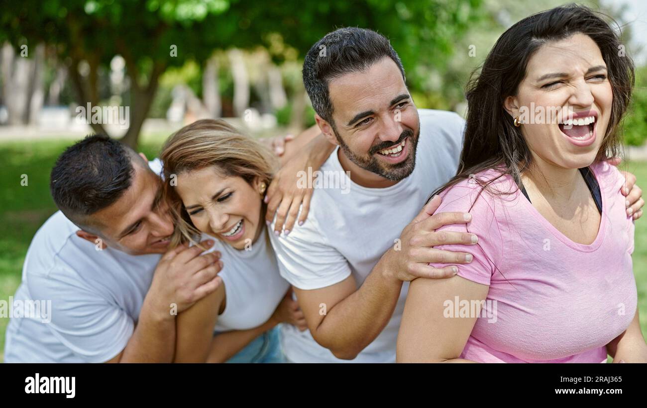Group of people hugging each other smiling at park Stock Photo - Alamy