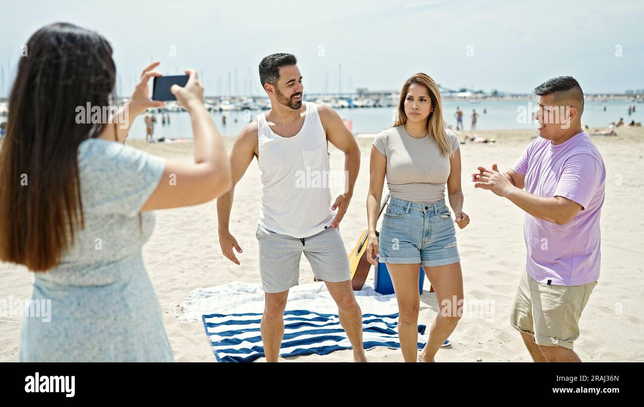 Group of people recording video by smartphone dancing at beach Stock ...