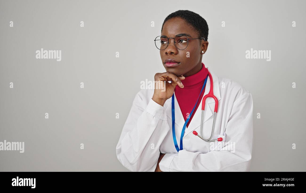 African american woman doctor standing with doubt expression thinking ...