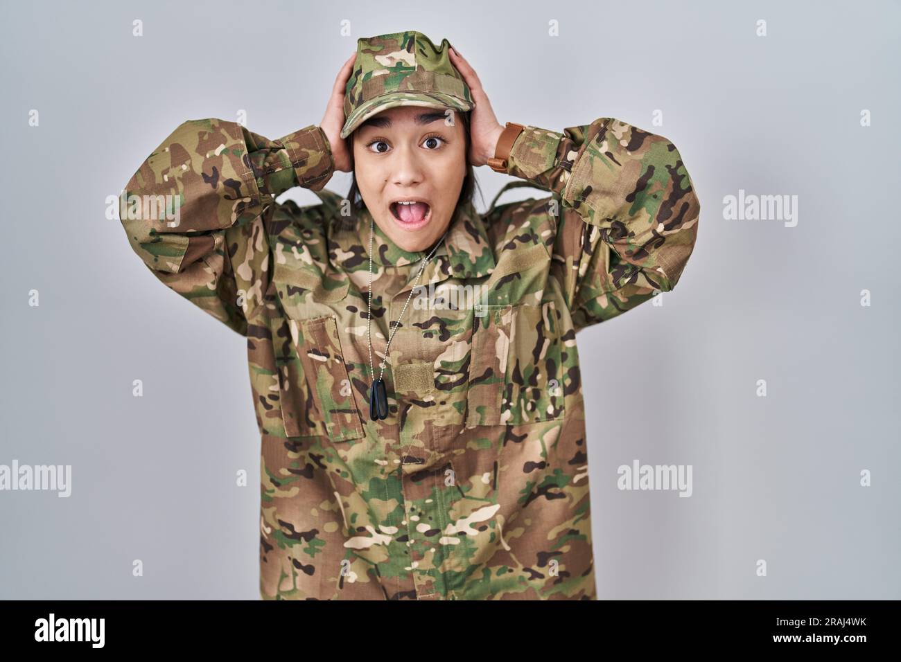 Young south asian woman wearing camouflage army uniform crazy and ...