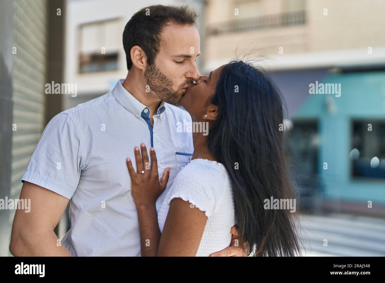 Man And Woman Interracial Couple Hugging Each Other And Kissing At