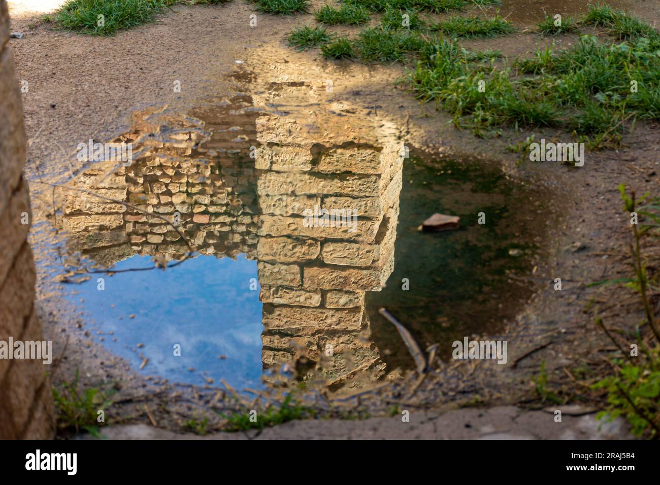 Close-up Roman ruins reflection on the rainwater pond in the ancient ...