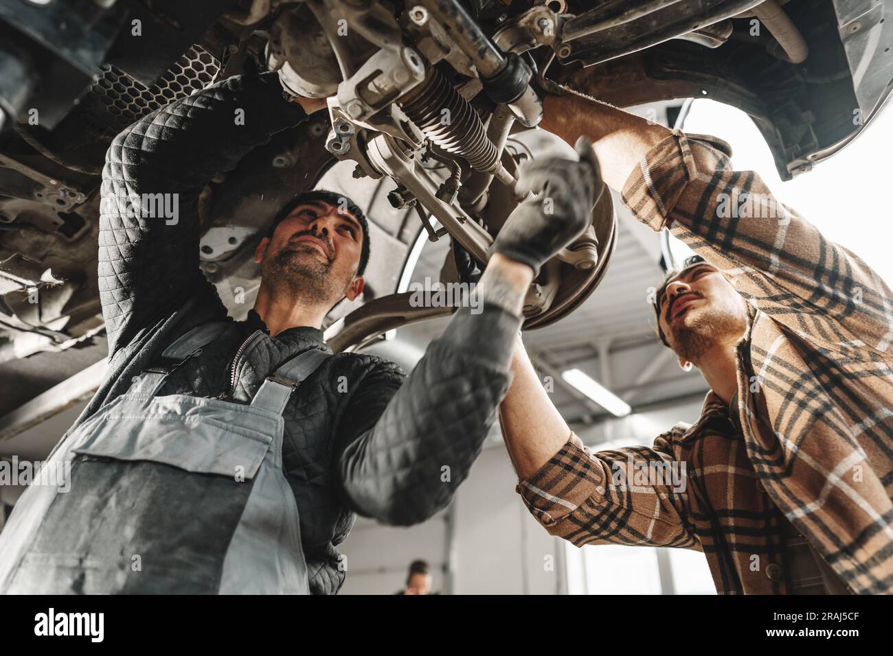 Two men servicing vehicle hi-res stock photography and images - Alamy