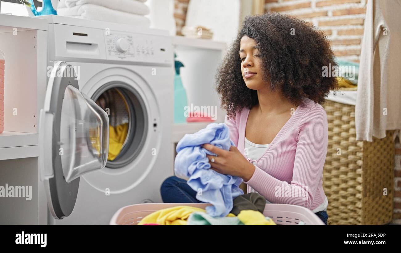 African american woman washing clothes at laundry room Stock Photo - Alamy