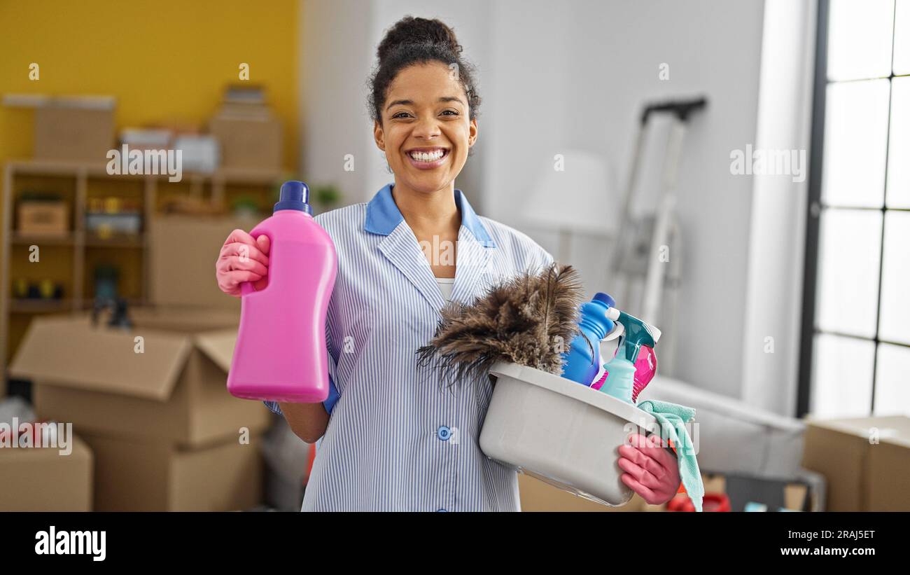 African american woman clean professional holding cleaner products ...