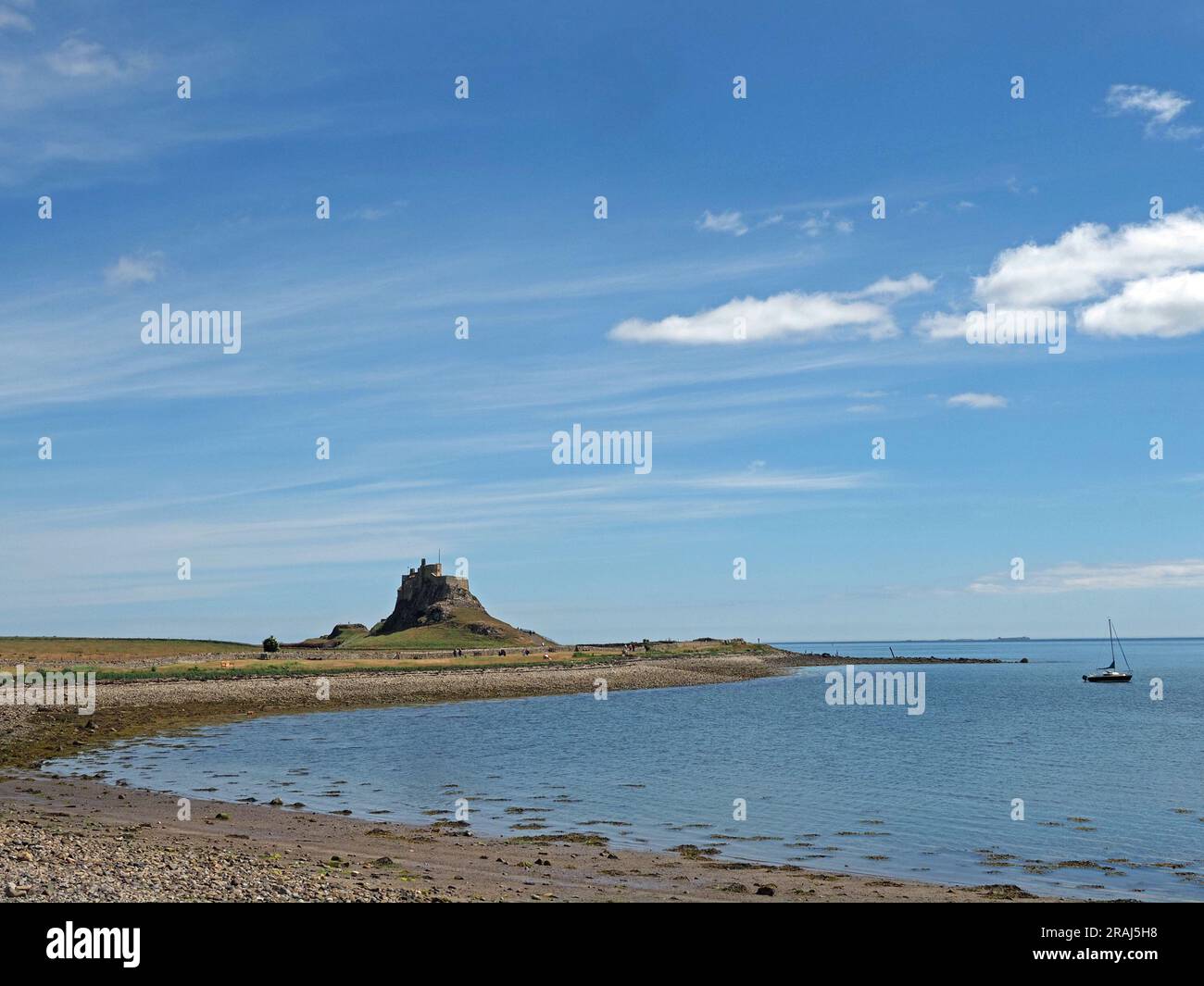 classic sunny view of Lindisfarne Castle on highest part of whinstone ...
