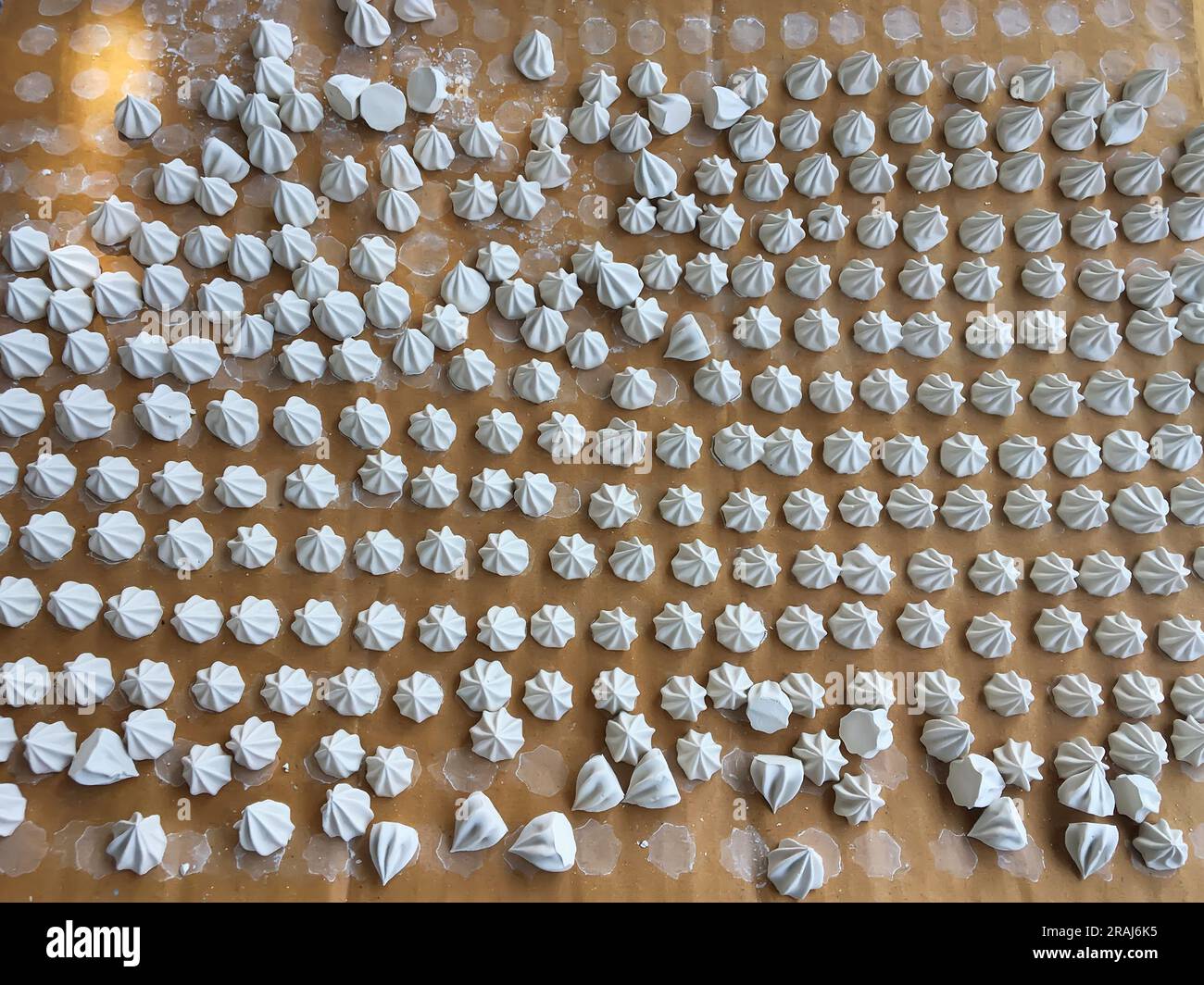 White clay filler was laid out to dry in the sun. It's a pressed powder ...