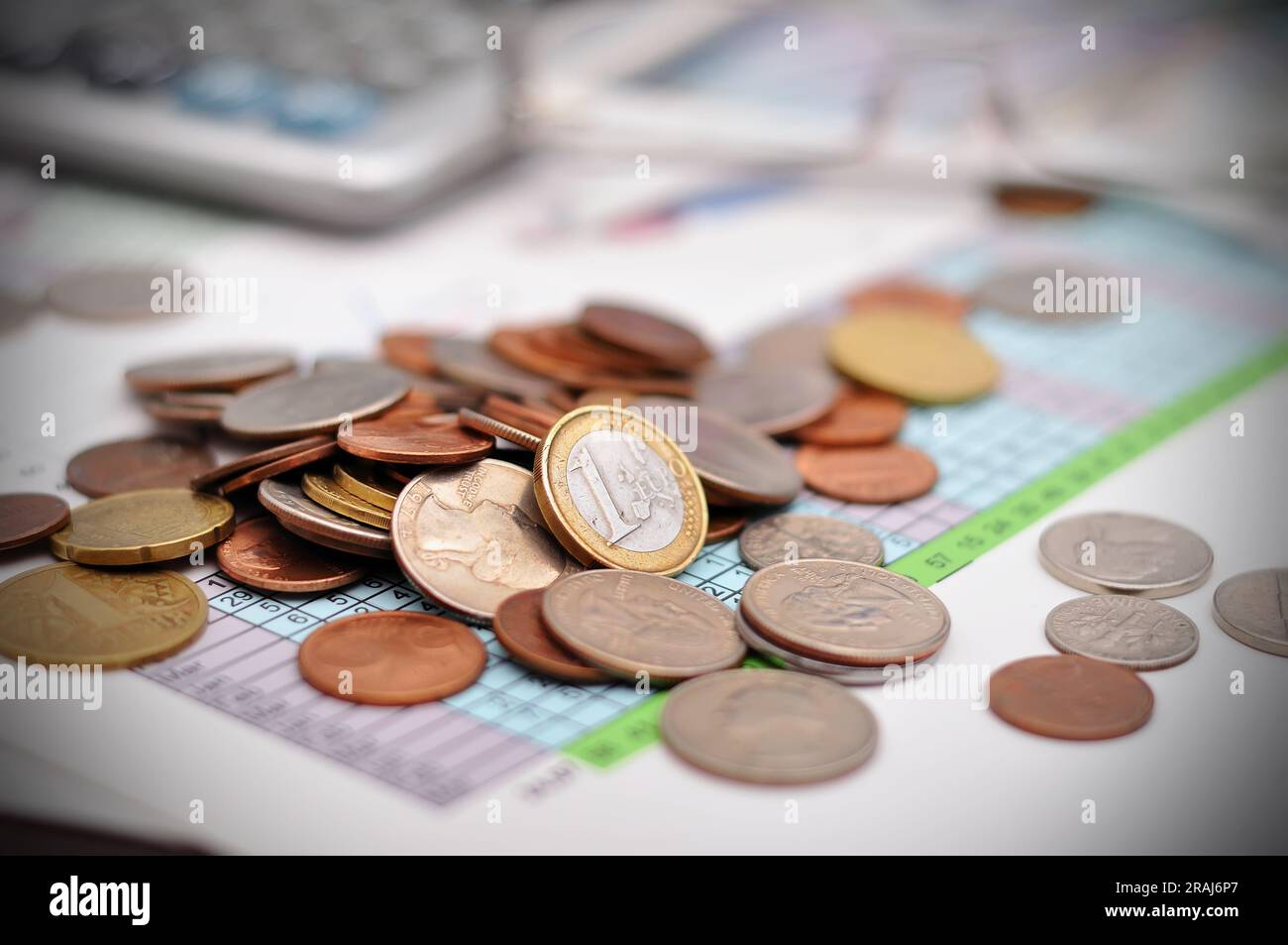 Pile of coins on annual report Stock Photo - Alamy
