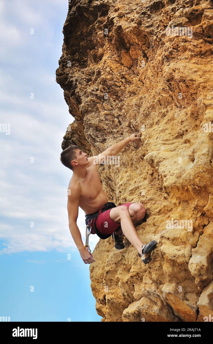 muscular man climbing on mountain Stock Photo - Alamy