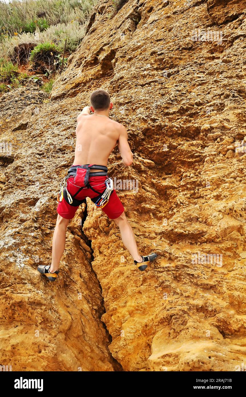 Climber climbing a rocky wall hi-res stock photography and images - Alamy