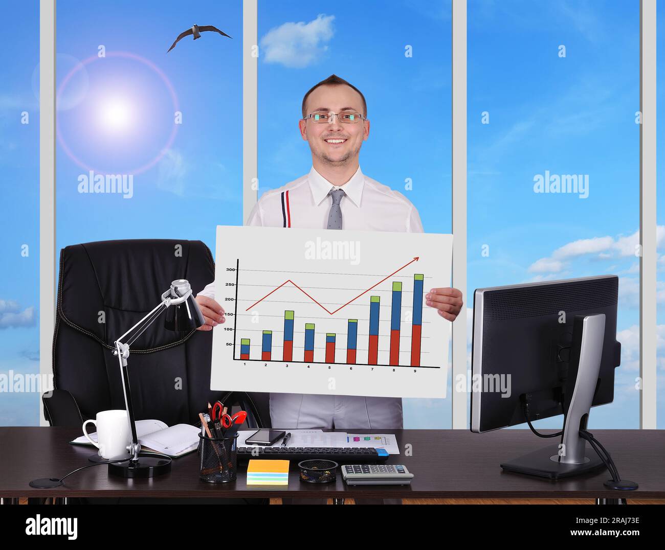 businessman standing in office and holding placard with chart Stock ...