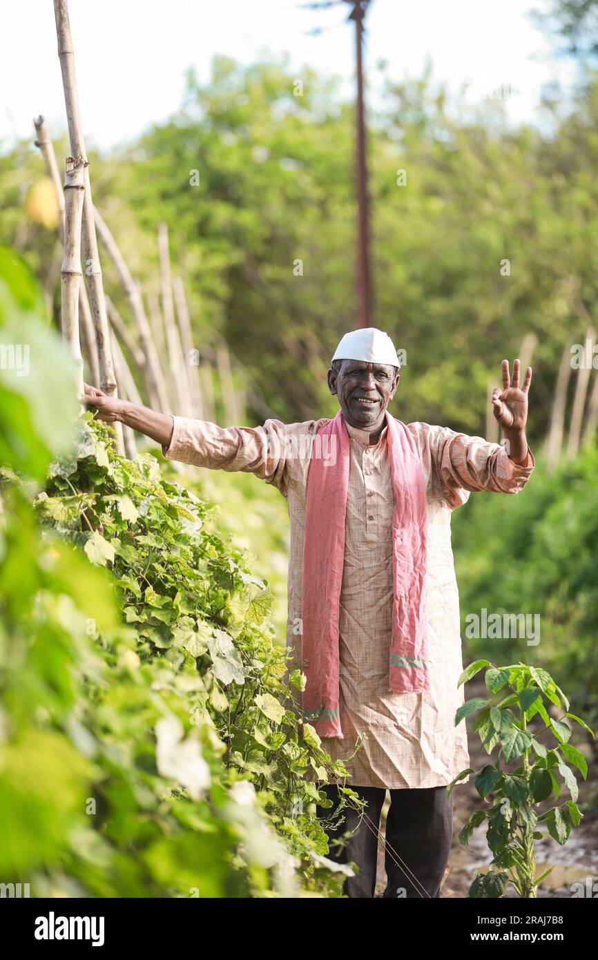 Indian farming Happy indian farmer standing in farm, sowing Empty Hands ...