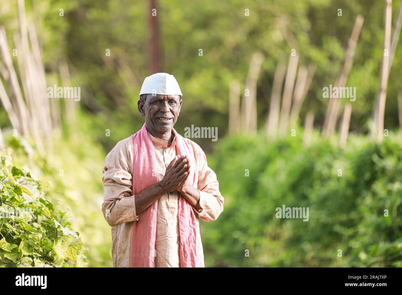 Indian farming Happy indian farmer standing in farm, sowing Empty Hands ...