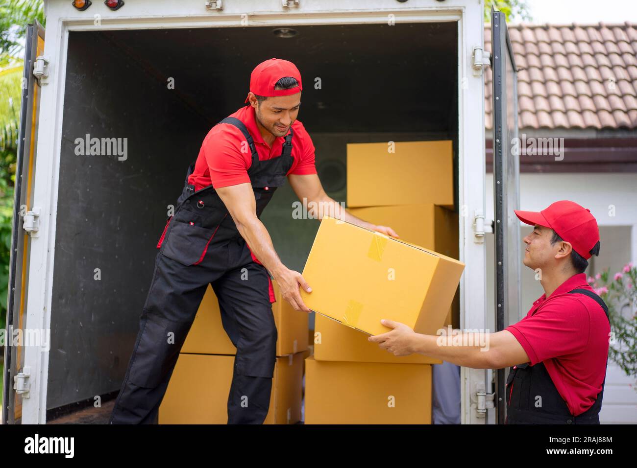 Delivery man move items to the house. Service and delivery concept ...