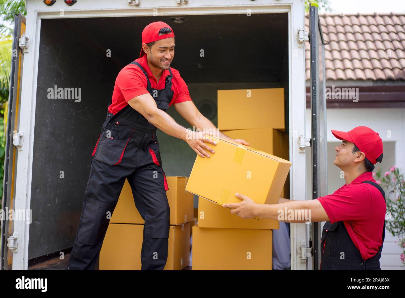Delivery man move items to the house. Service and delivery concept ...