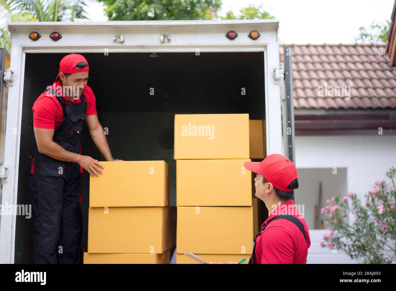 Delivery service men carrying hi-res stock photography and images - Alamy