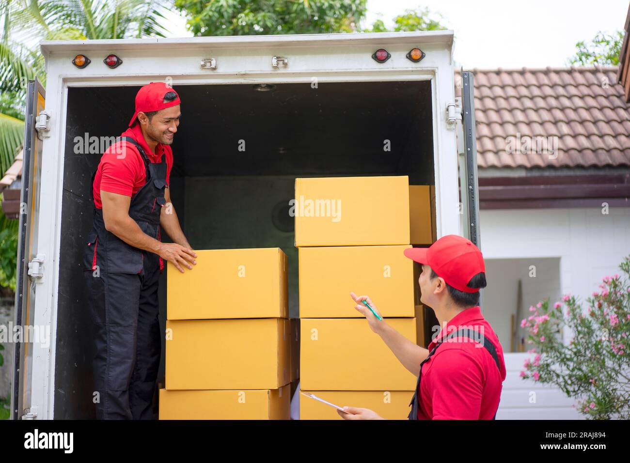 Delivery man move items to the house. Service and delivery concept ...